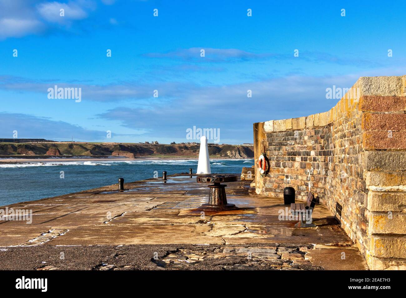 CULLEN BAY MORAY FIRTH SCOTLAND THE HARBOUR WALL JETTY AND SMALL WHITE ...