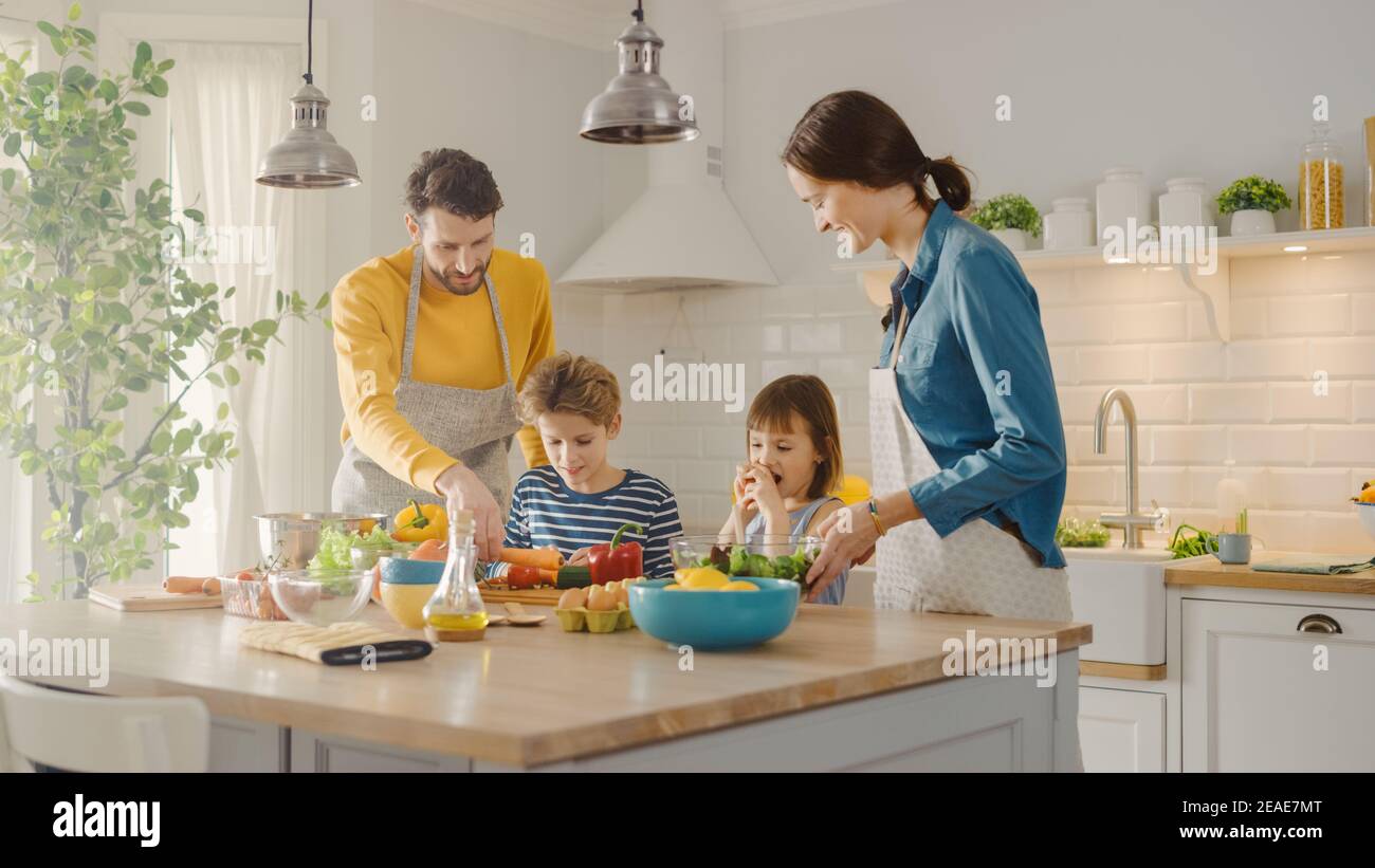 In Kitchen: Family of Four Cooking Together Healthy Dinner. Mother ...