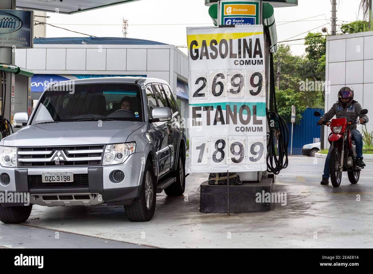 Brazilian motorists fill up with petrol at one of the petrol stations ...
