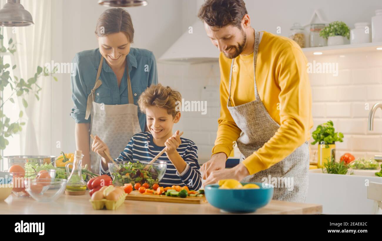 In Kitchen: Family of Three Cooking Together Healthy Dinner. Dad and ...