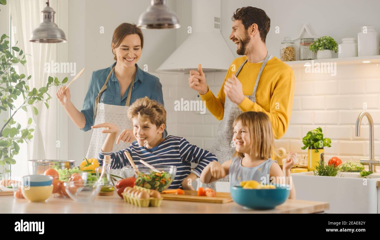In Kitchen: Family of Four Cooking Together Healthy Dinner, Fool Around ...