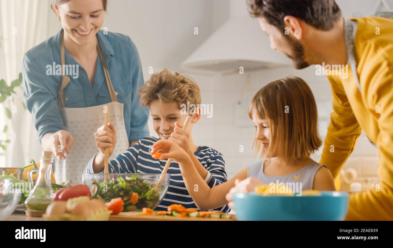 In Kitchen: Family of Four Cooking Together Healthy Dinner. Mother ...