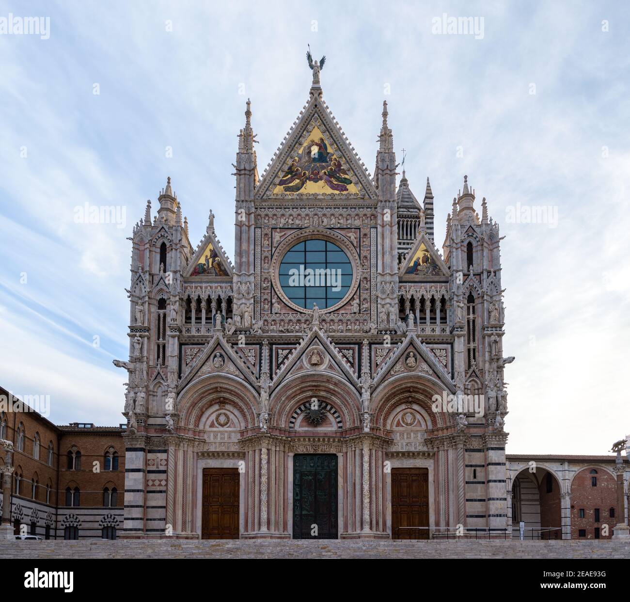 Duomo di Siena at sunrise, a black and white marble church typical of ...