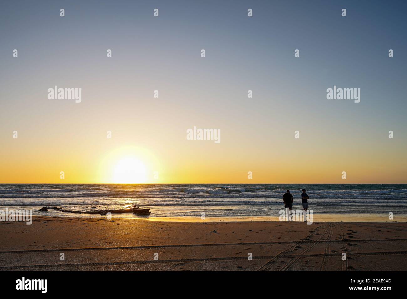 Cable beach sunset, two silhouettes on background Stock Photo - Alamy