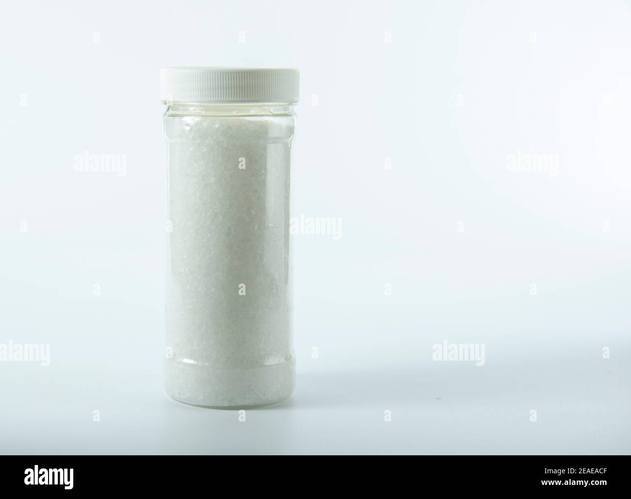Transparent jar with salt on a light background Stock Photo - Alamy