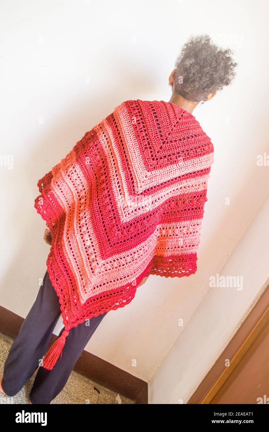 Elegant red and pink poncho or shawl tied by a young smiling and happy ...