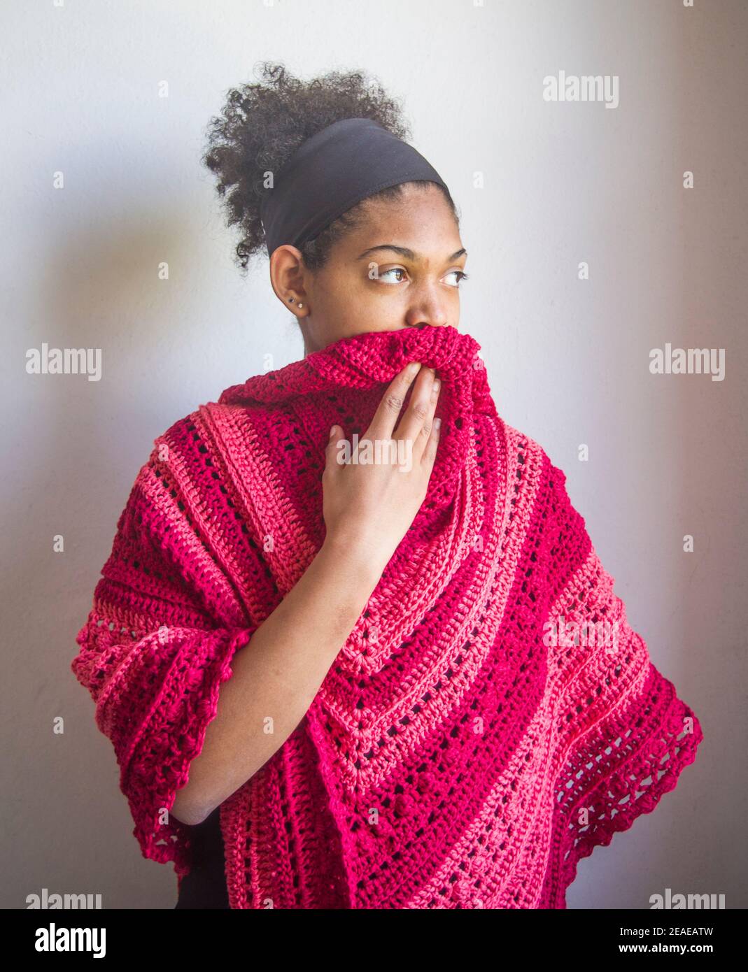 Elegant red and pink poncho or shawl tied by a young smiling and happy ...