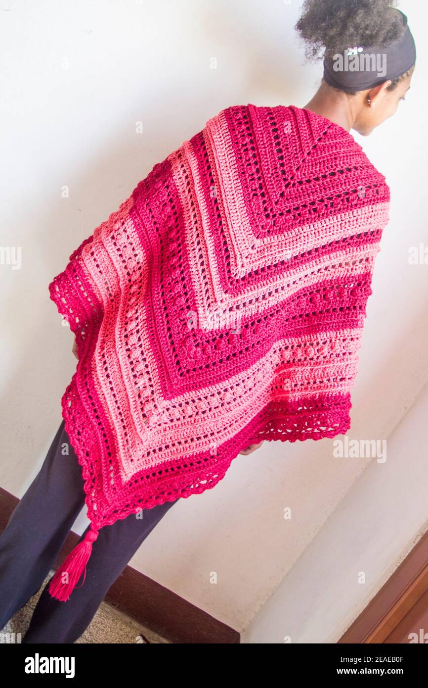 Elegant red and pink poncho or shawl tied by a young smiling and happy ...