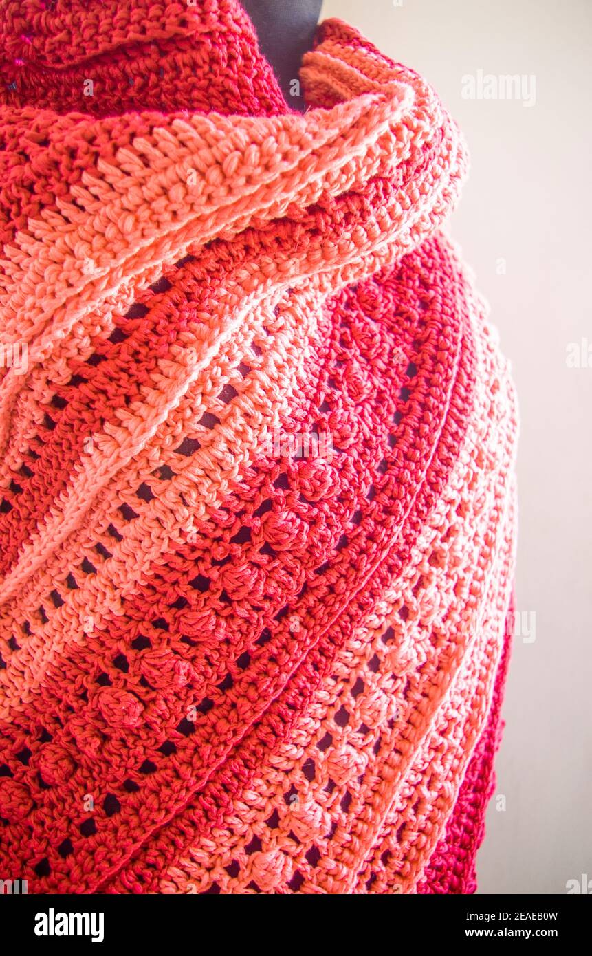 Elegant red and pink poncho or shawl tied by a young smiling and happy ...
