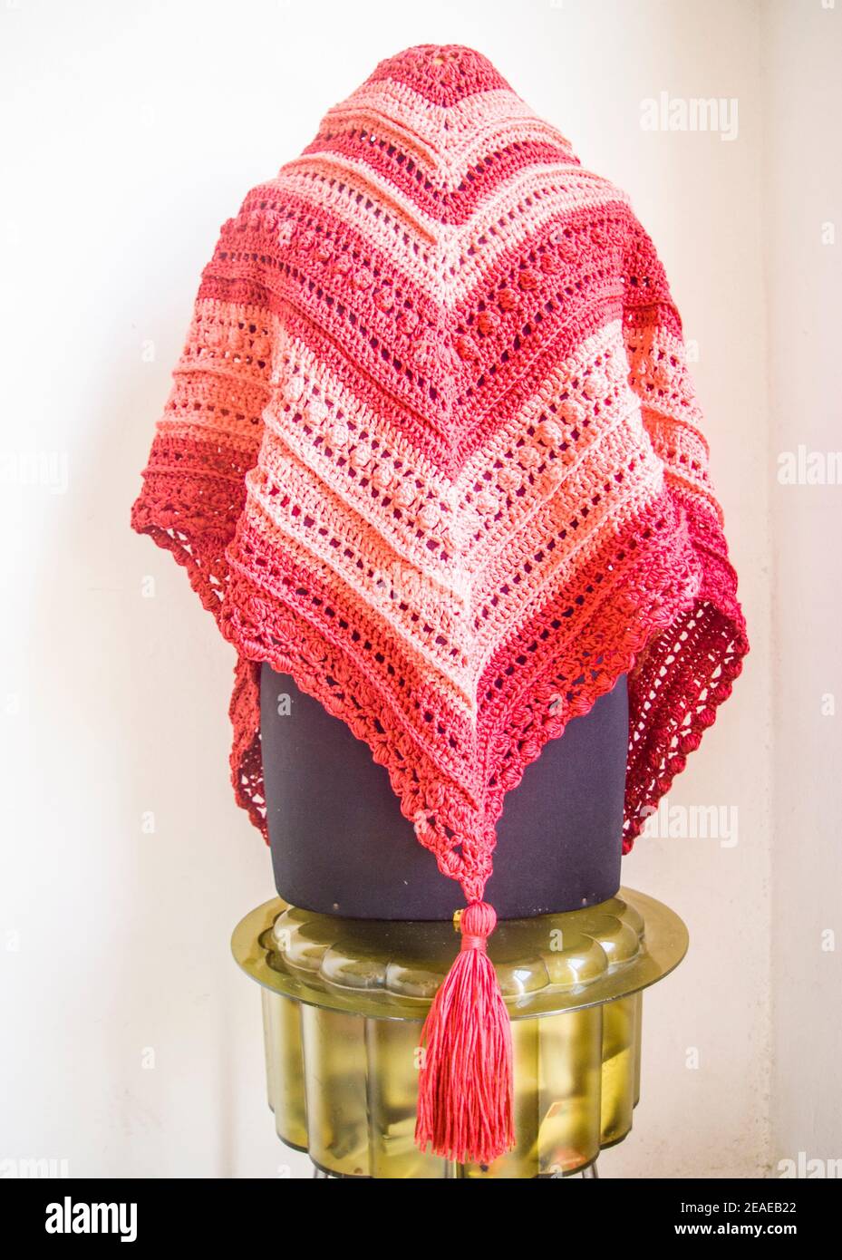 Elegant red and pink poncho or shawl tied by a young smiling and happy ...
