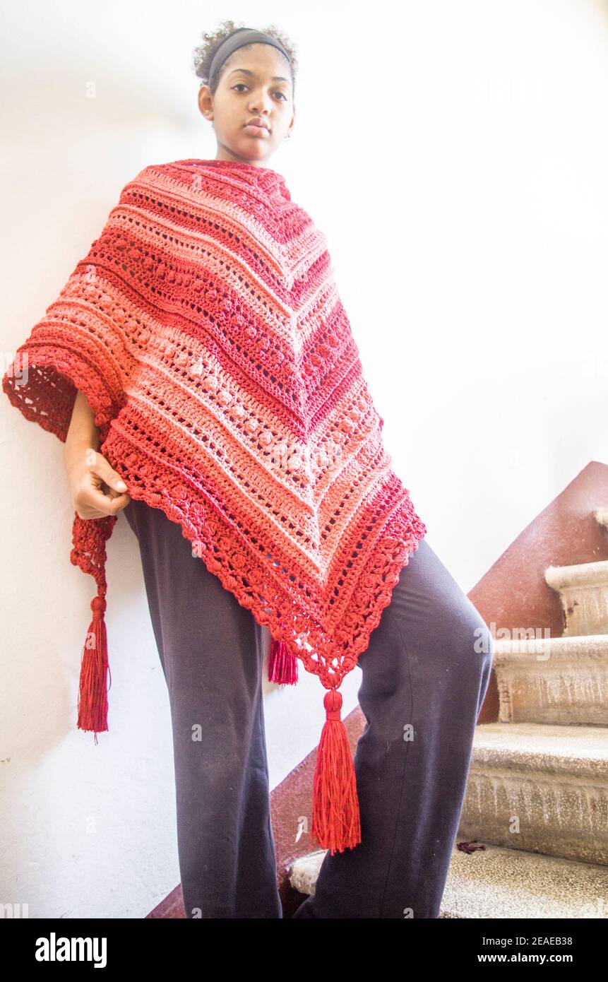 Elegant red and pink poncho or shawl tied by a young smiling and happy ...