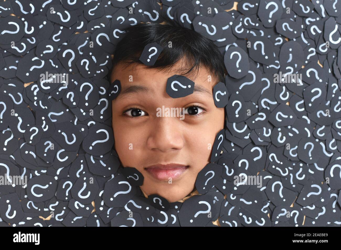 Boy submerged from question mark. Concept of question, curiosity and choices Stock Photo - Alamy
