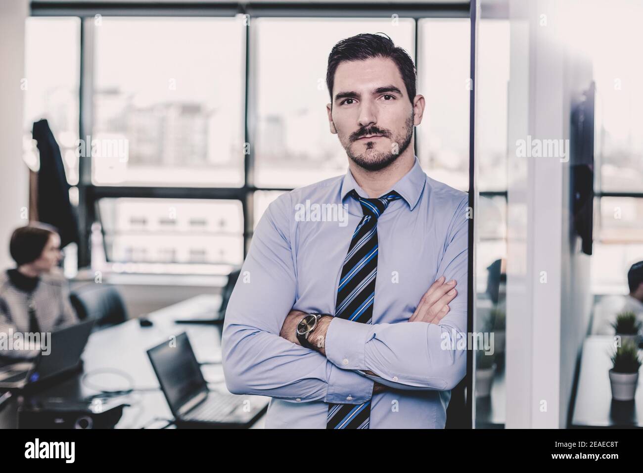 Team leader with coworkers working in office Stock Photo - Alamy