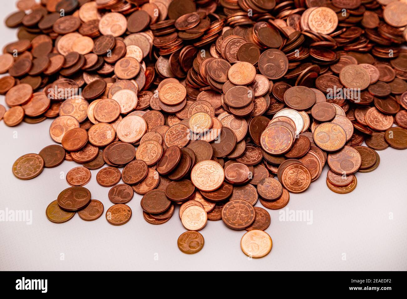 Many small euro coins on each other on white background Stock Photo - Alamy
