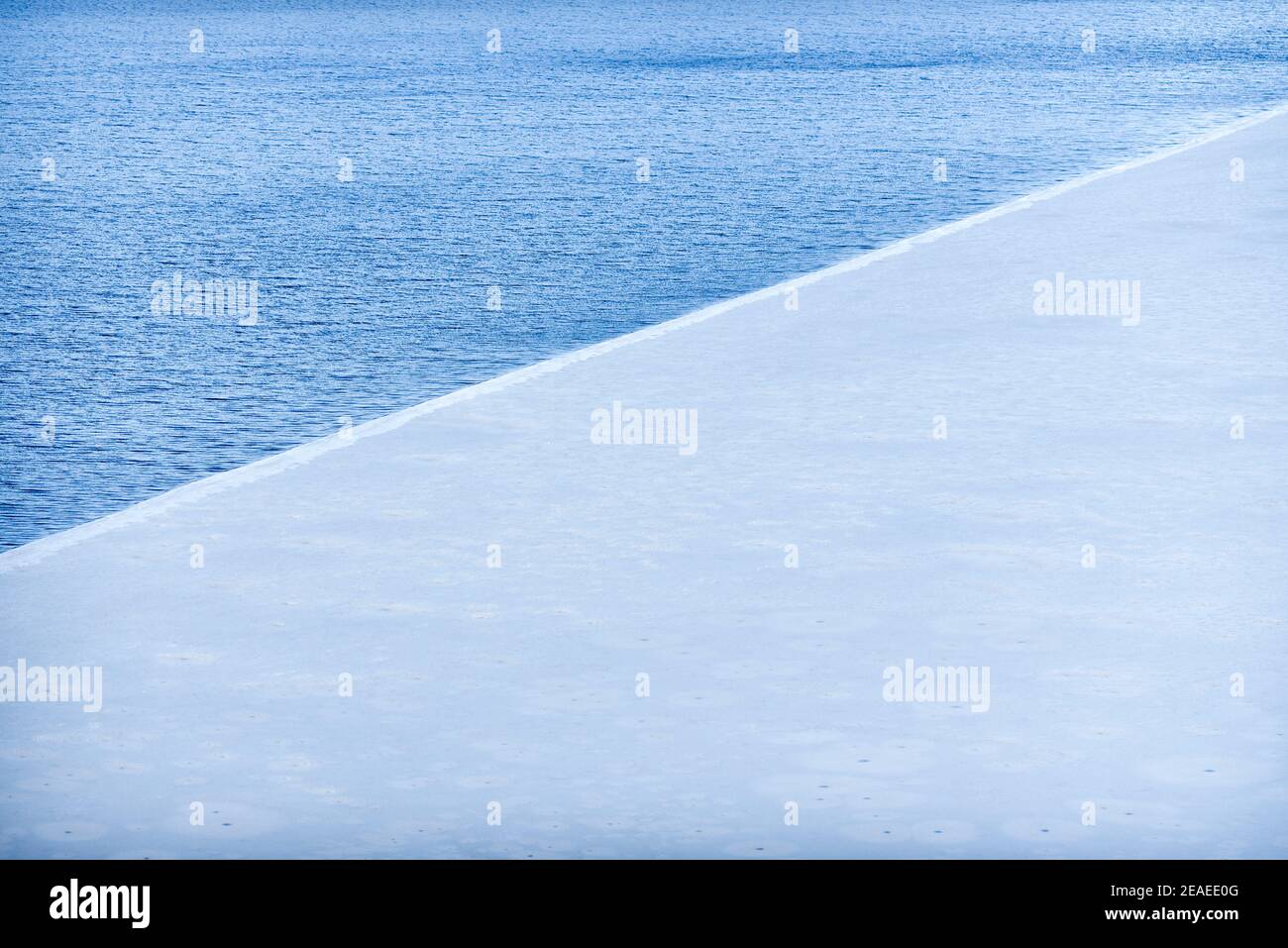 Snow and water together on one lake Stock Photo - Alamy