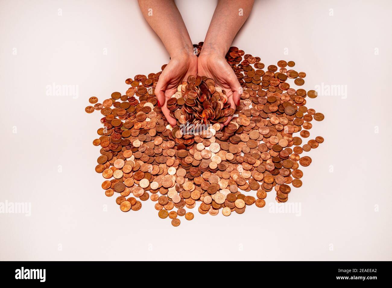 Female hands holding many small euro coins on white background Stock ...