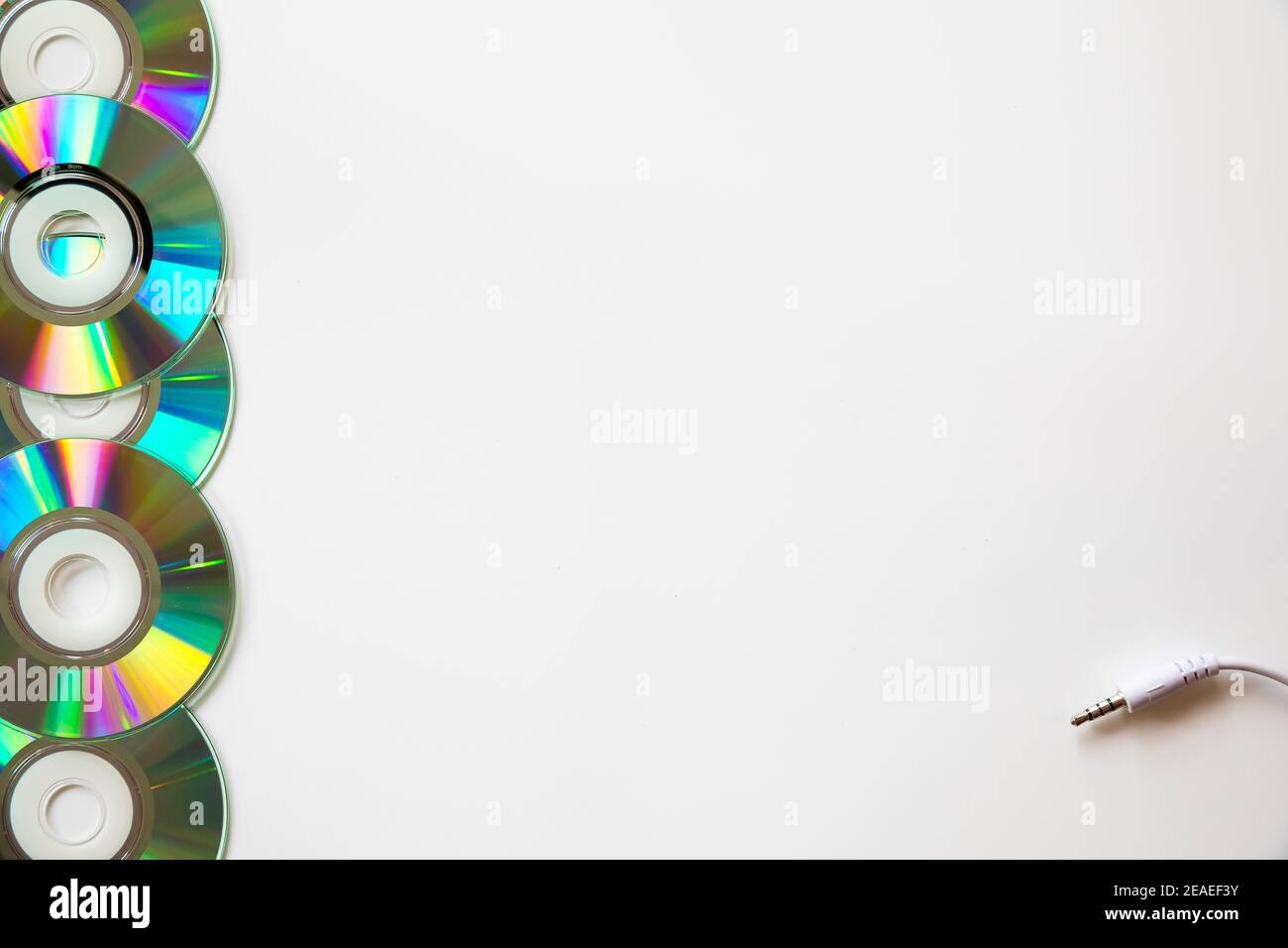 Several DVDs isolated on white background with a jack connector Stock ...