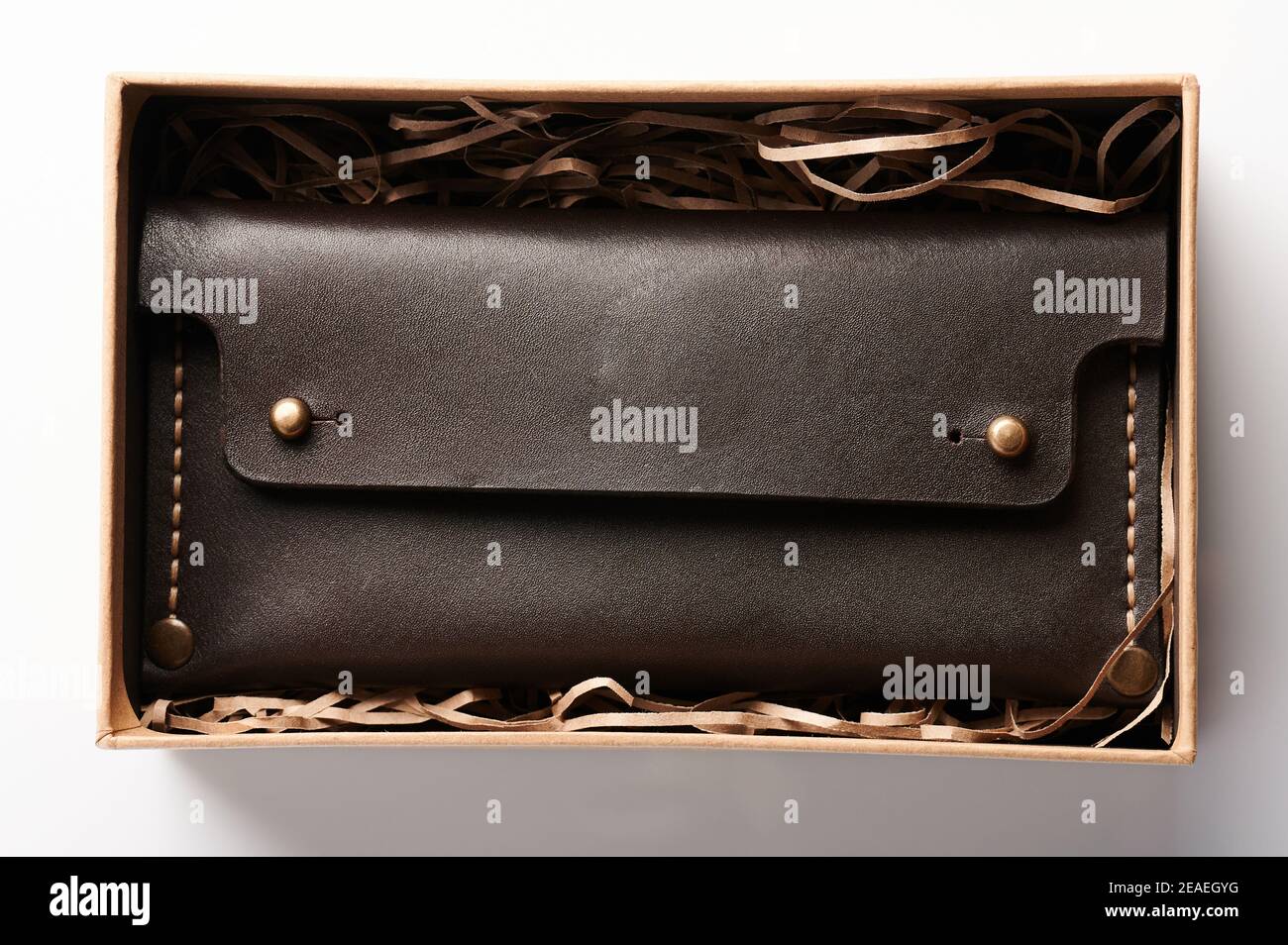 Brown leather purse in box above top view isolated Stock Photo - Alamy