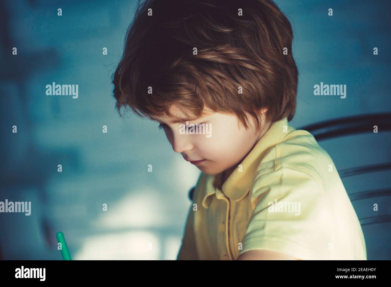 Happy cheerful child drawing with brush using a lot of painting tools ...