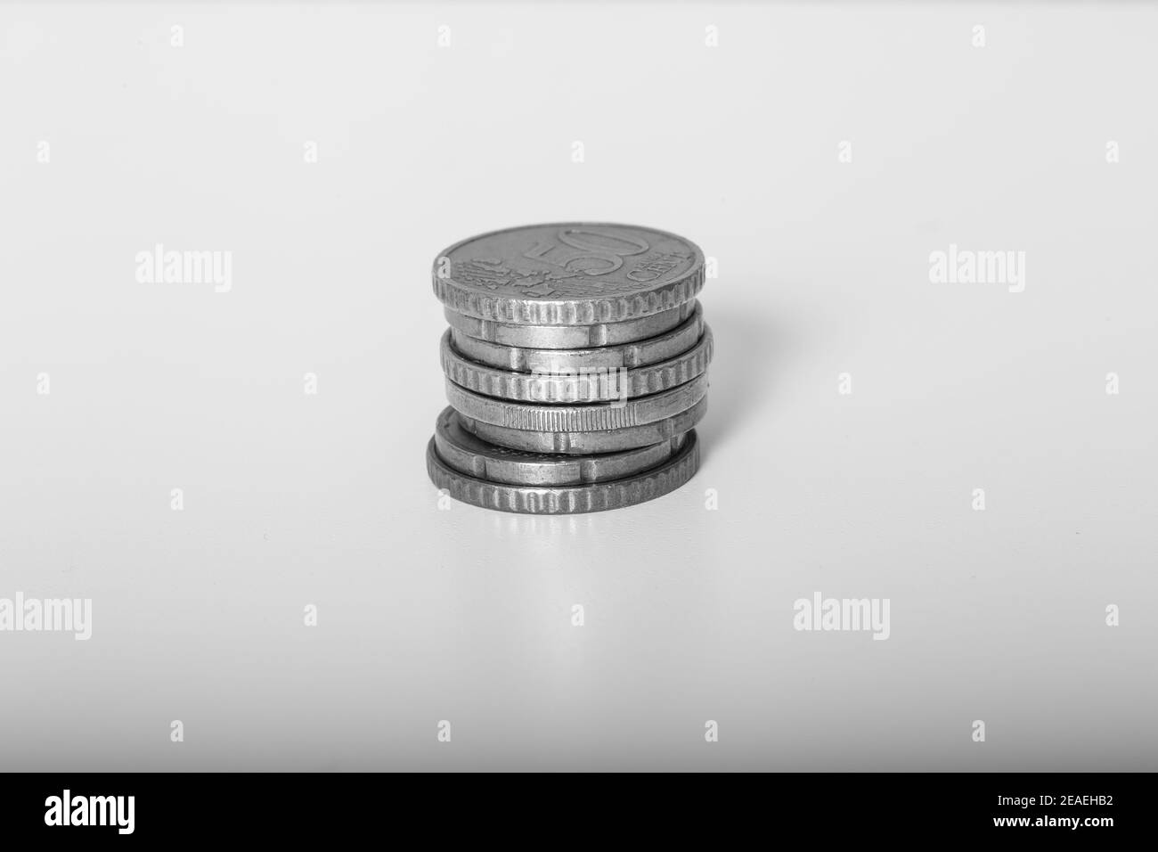 Coins cash money in piles, Isolated on white background Stock Photo - Alamy