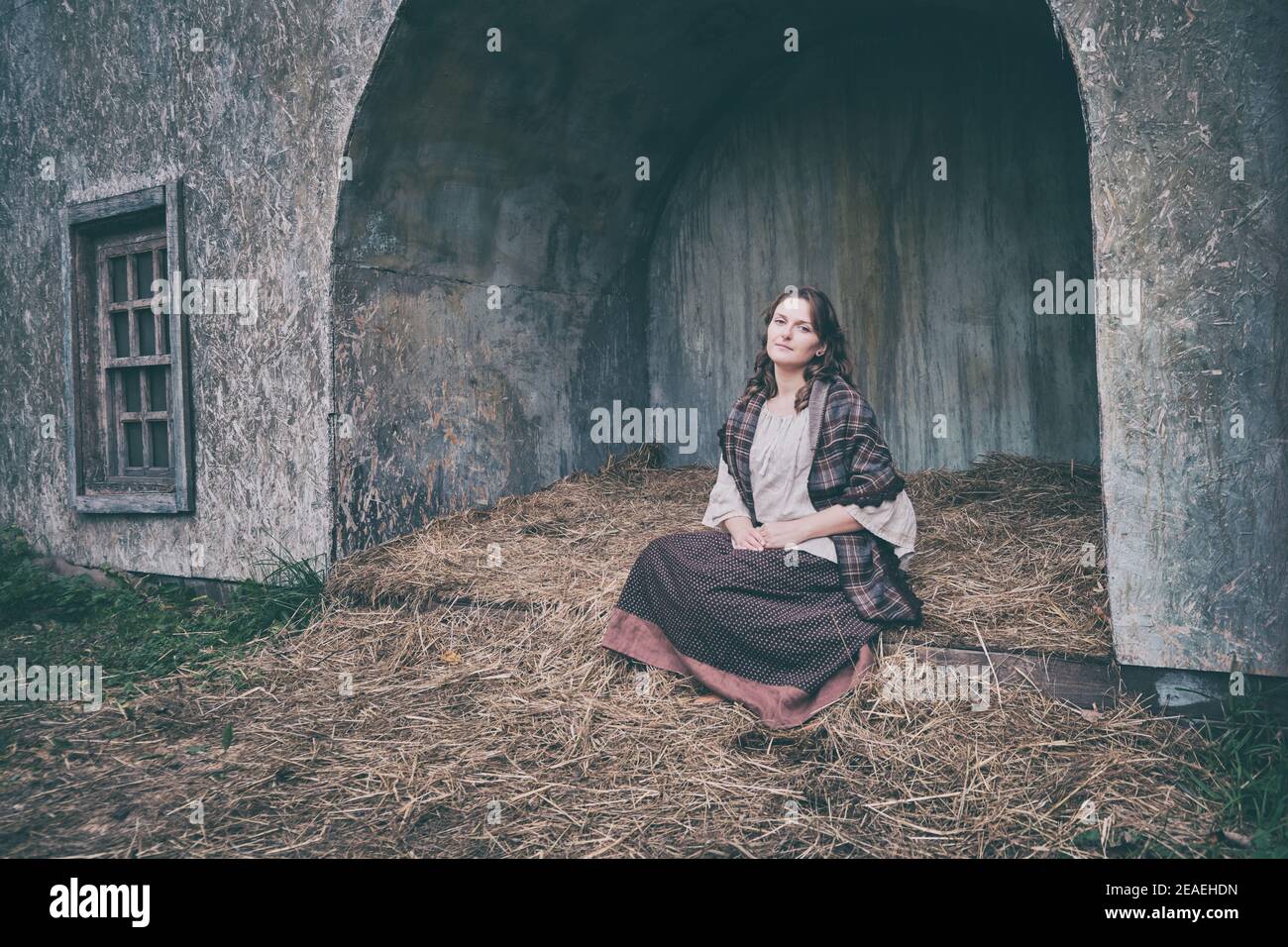 A woman sits on the hay in a vintage town in medieval Europe Stock ...