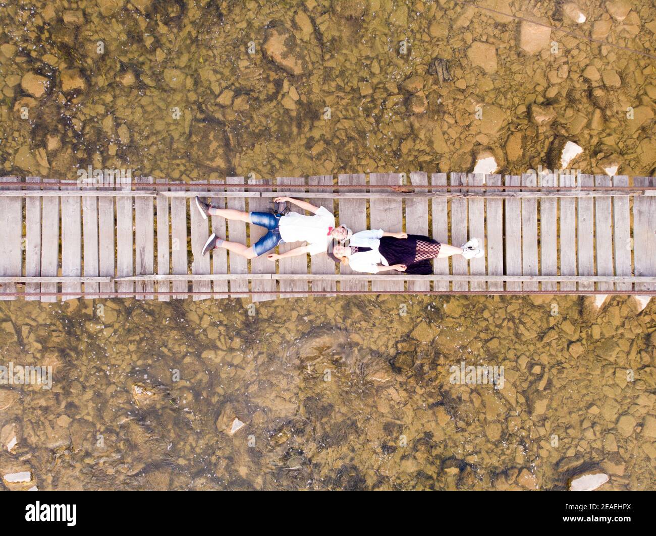 Girl lying on wooden bridge hi-res stock photography and images - Alamy
