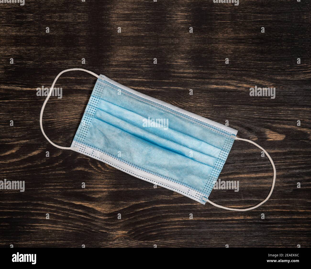 Top view of face mask or surgical mask lays on wooden table with copy ...