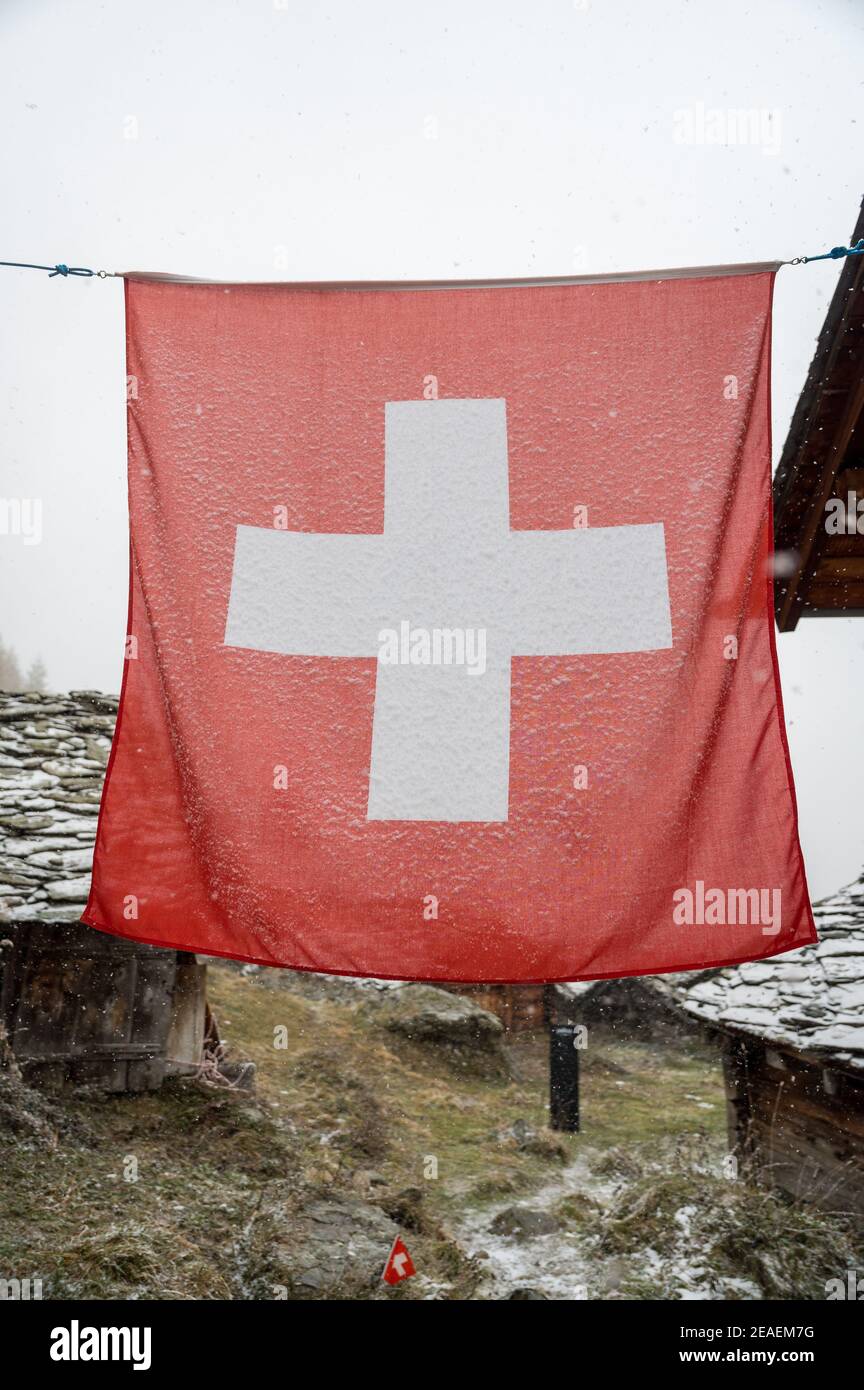 swiss flag with snow flakes in valais Stock Photo - Alamy