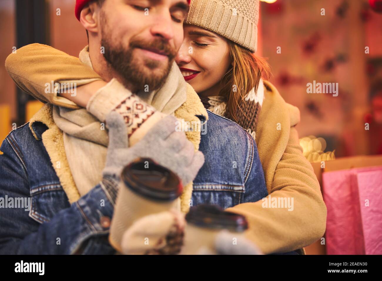 Caring female embracing boyfriend in city street Stock Photo - Alamy