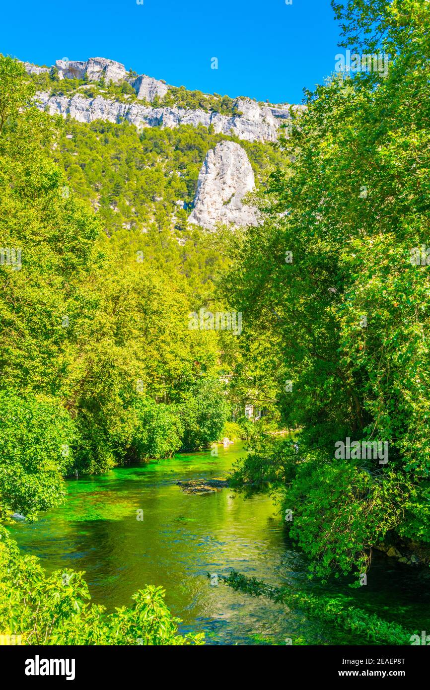 La sorgue river passing through Fontaine de Vaucluse village in France ...