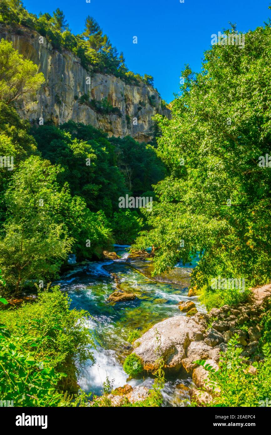 La sorgue river passing through Fontaine de Vaucluse village in France ...