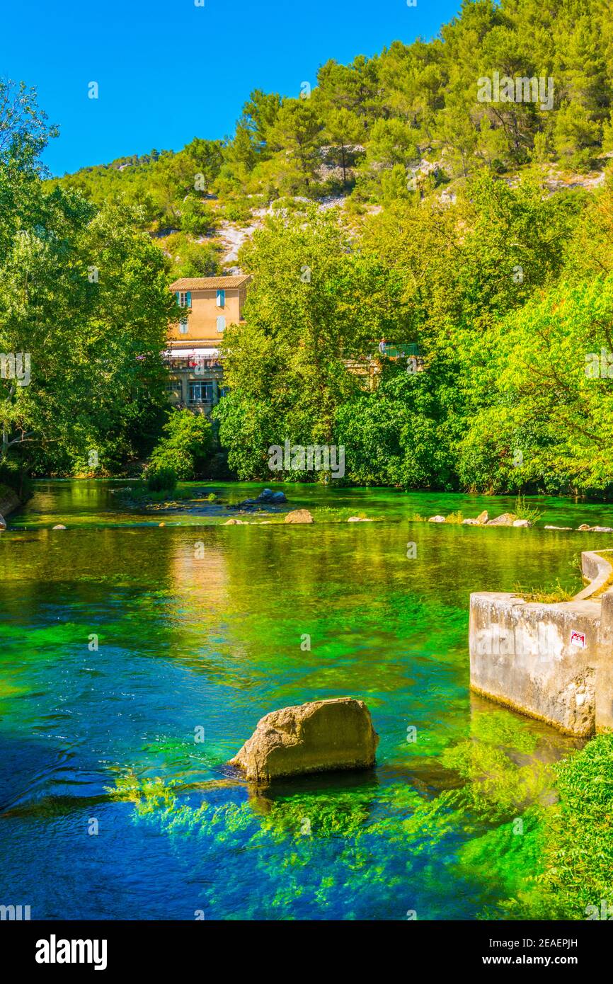 La sorgue river passing through Fontaine de Vaucluse village in France ...