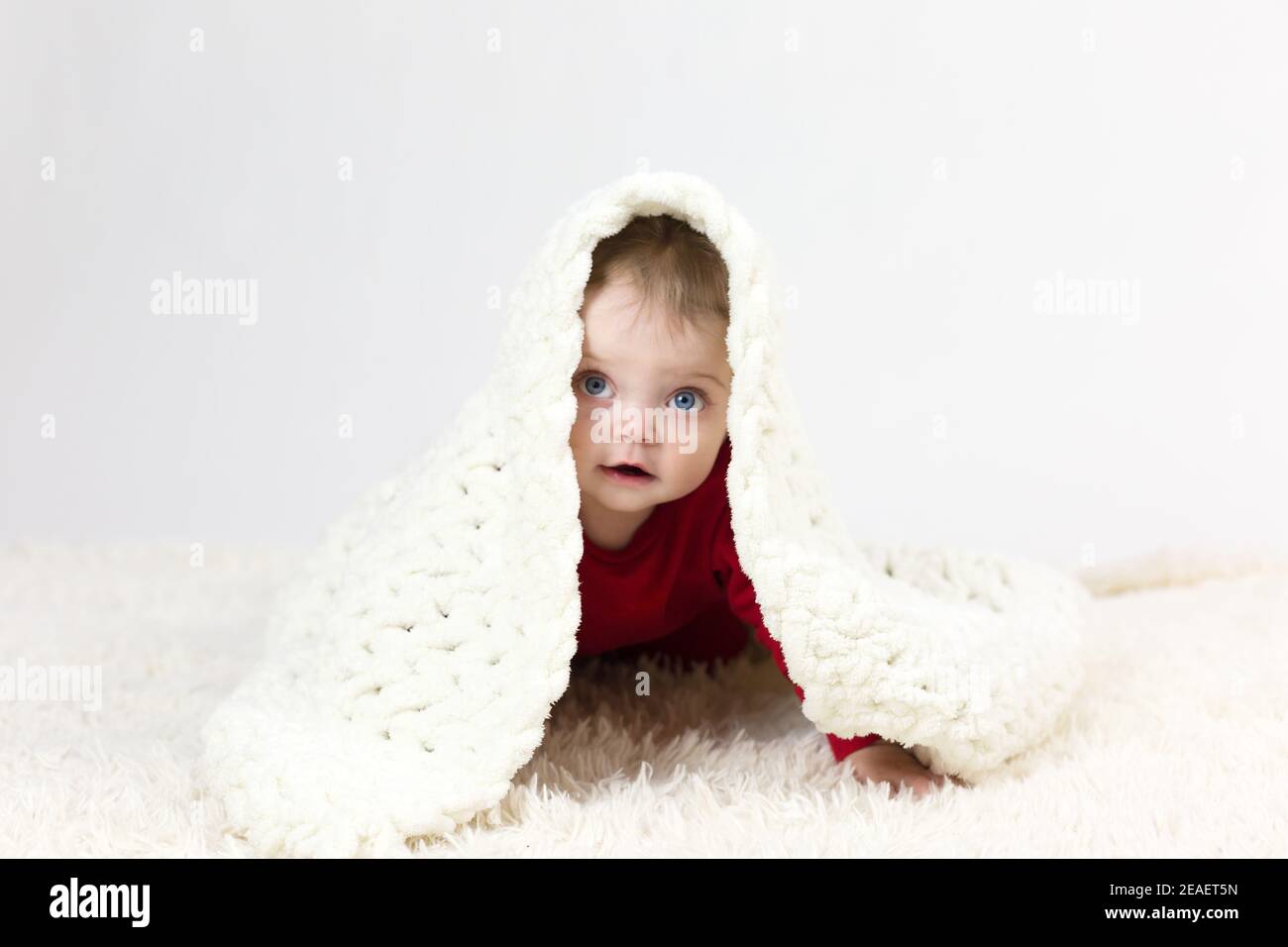 Baby hiding under blanket hi-res stock photography and images - Alamy