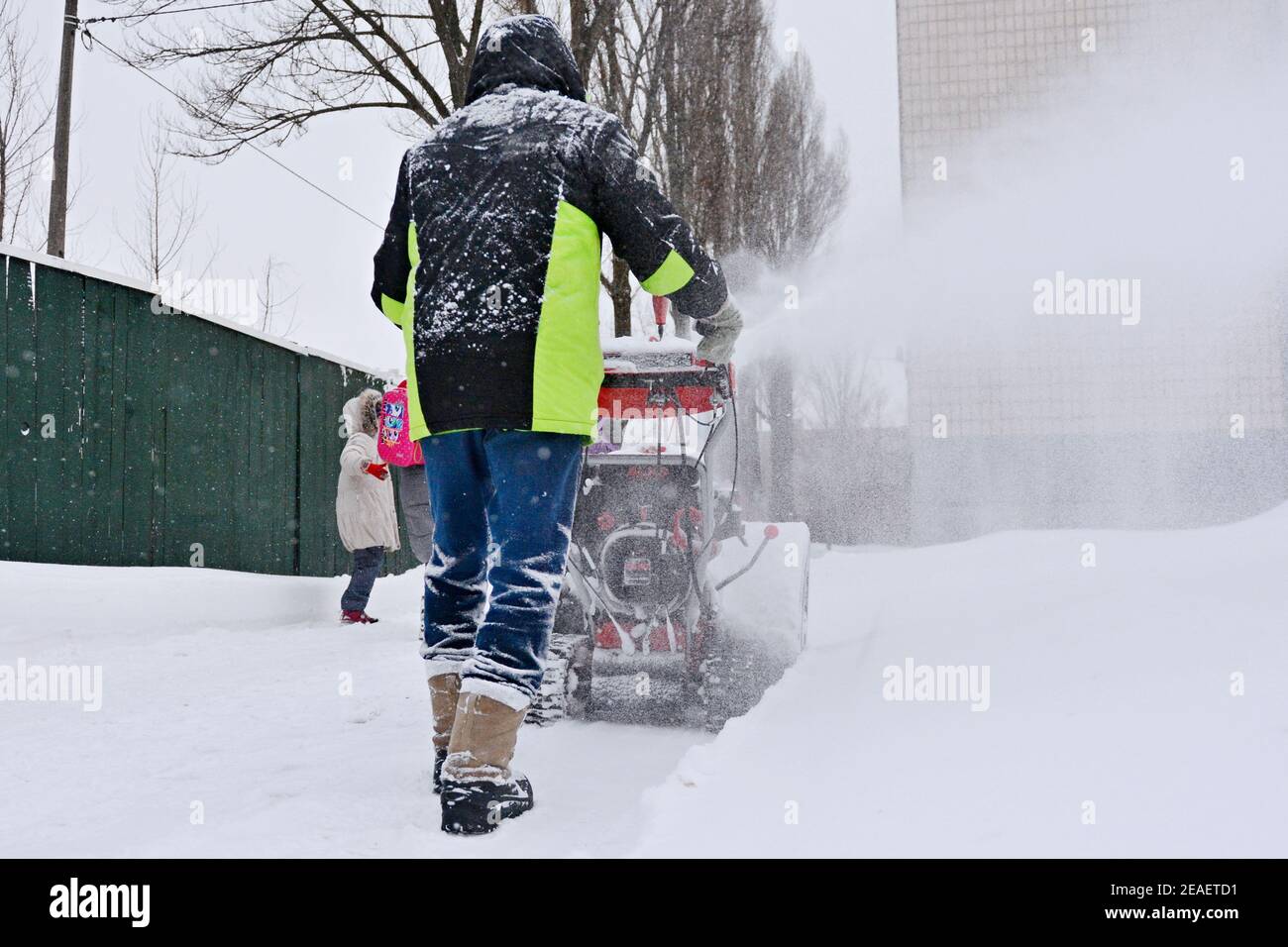 A municipal worker clearing snow from the Street after the snowfall in ...