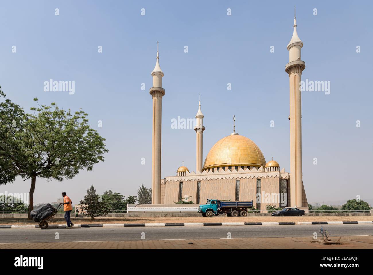 Abuja, Nigeria - 27 Jan 2021: A man pushes a cartwheel along an empty ...