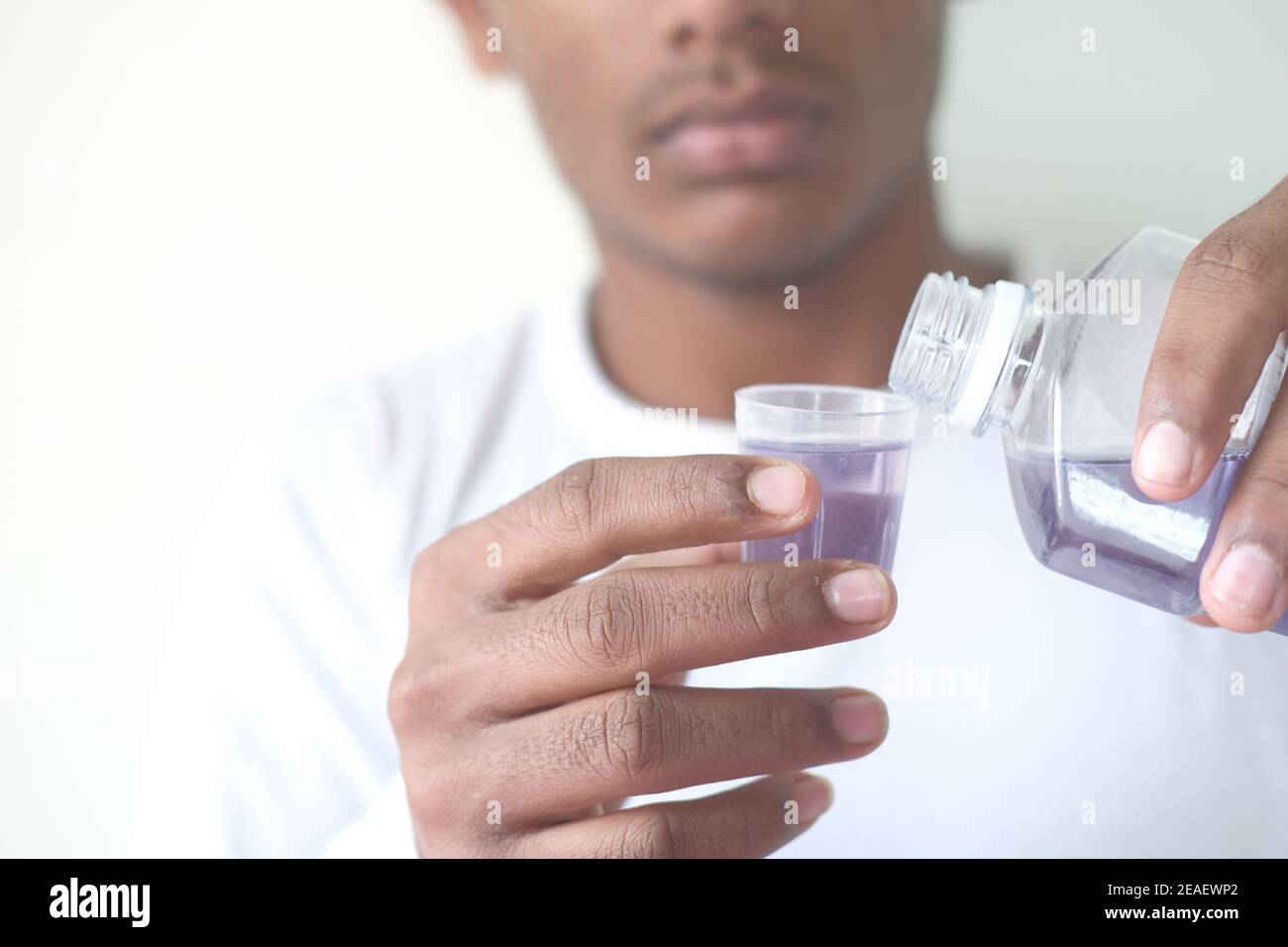 mouthwash liquid flowing into a cap Stock Photo - Alamy
