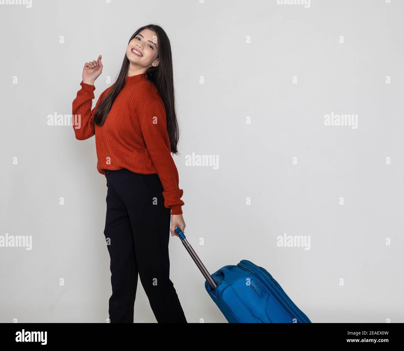 Portrait of a beautiful young lady pulling a stroller bag, happy woman ...