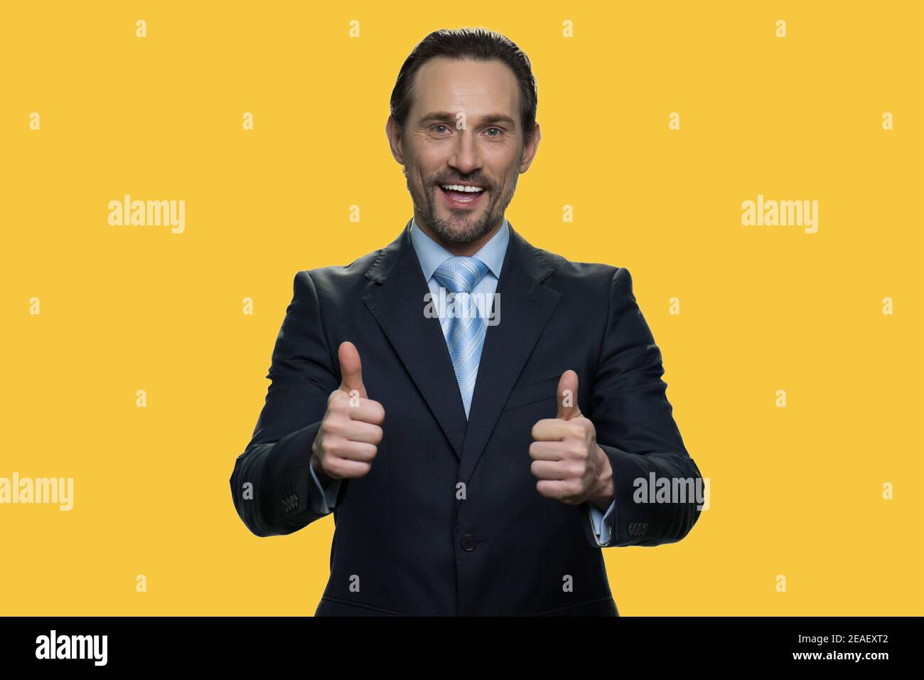 Portrait of businessman shows thumbs up Stock Photo - Alamy