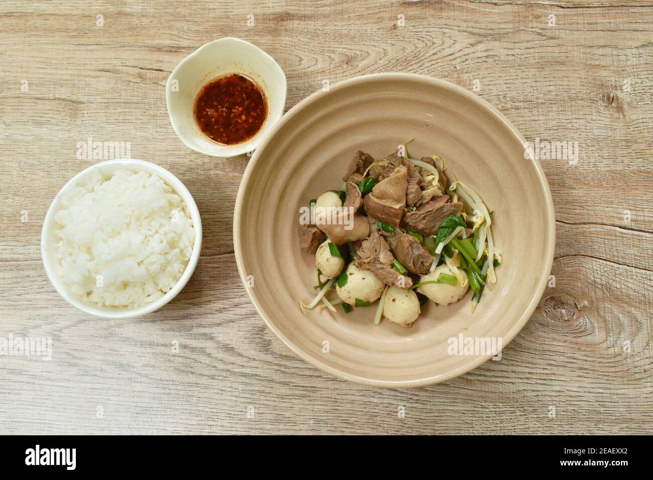 dry braised pork and ball with bean sprout on bowl dipping spicy sauce ...