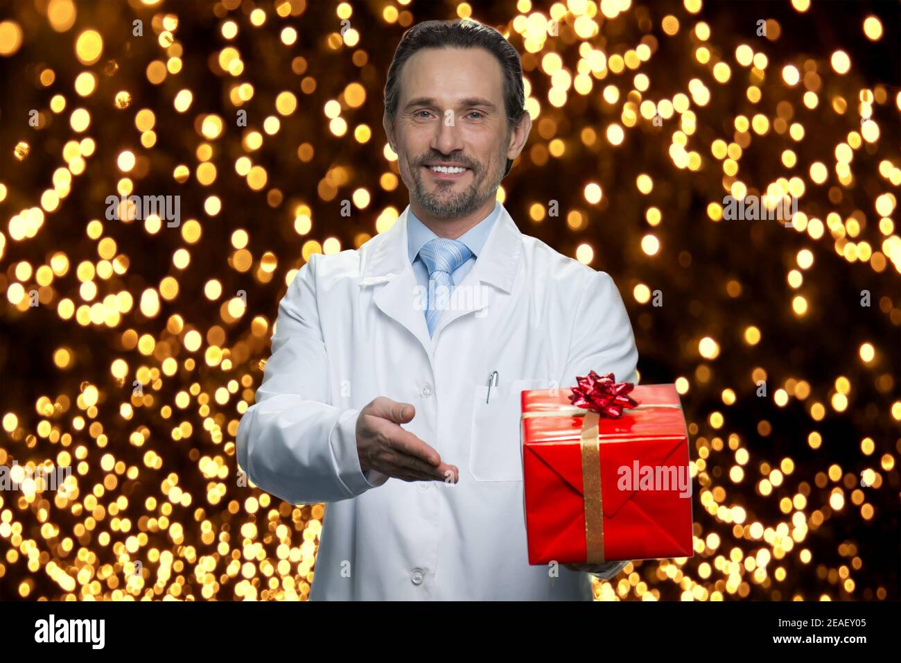 Handsome guy giving christmas present hi-res stock photography and ...