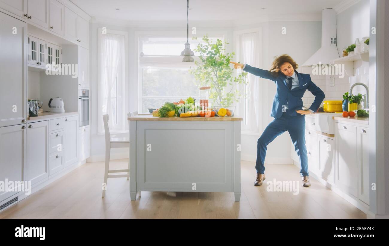 Energetic Funny Young Man with Long Hair Dancing in the Kitchen while ...