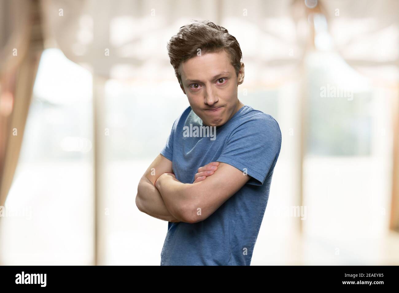 Caucasian furious boy with crossed arms Stock Photo - Alamy