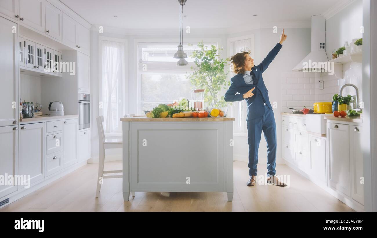 Energetic Funny Young Man with Long Hair Dancing in the Kitchen while ...