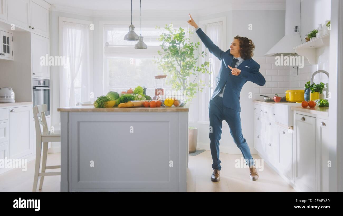 Energetic Funny Young Man with Long Hair Dancing in the Kitchen while ...