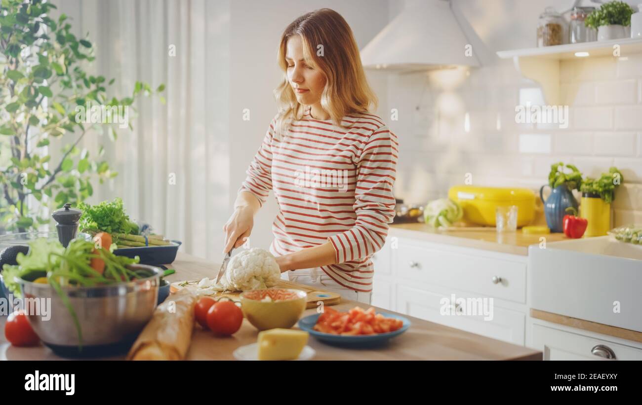 Young Female in Striped Jumper is Making a Healthy Organic Salad in a ...