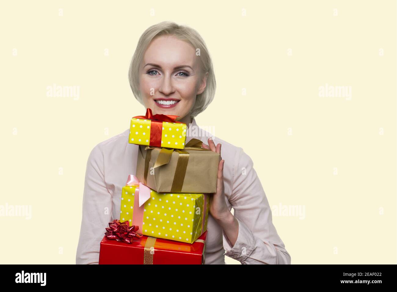 Joyful american woman is holding many gift boxes Stock Photo - Alamy