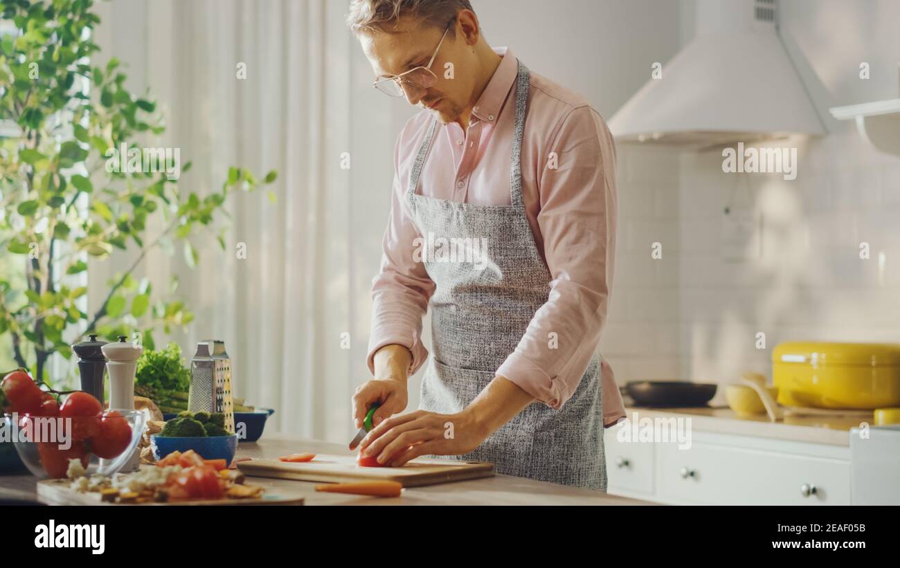 Shot of a Handsome Young Man Chopping a Green Chili Pepper with a Sharp ...