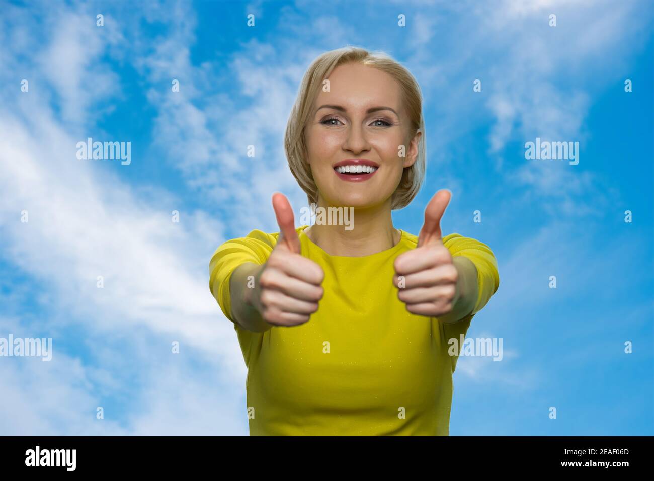 Woman is showing like gesture with both hands Stock Photo - Alamy
