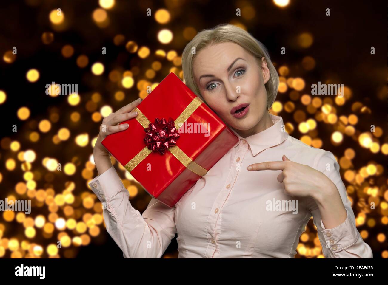 Excited blonde woman pointing hi-res stock photography and images - Alamy