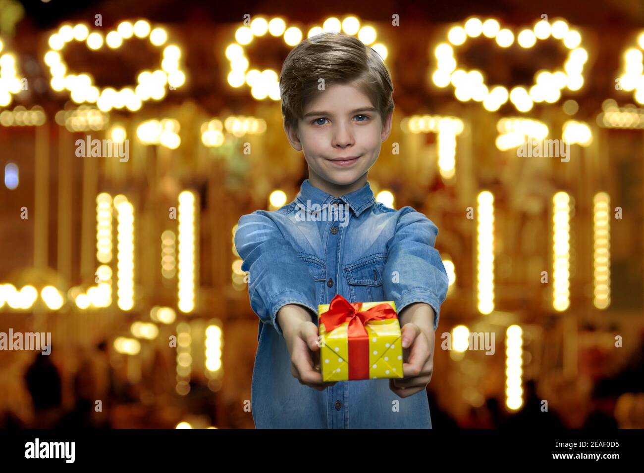Cute little boy is giving you a present Stock Photo - Alamy